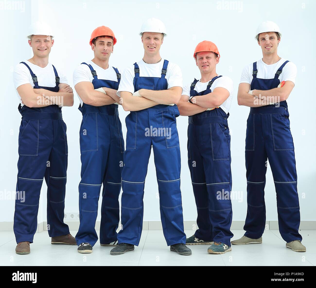team of professional builders in helmets Stock Photo - Alamy