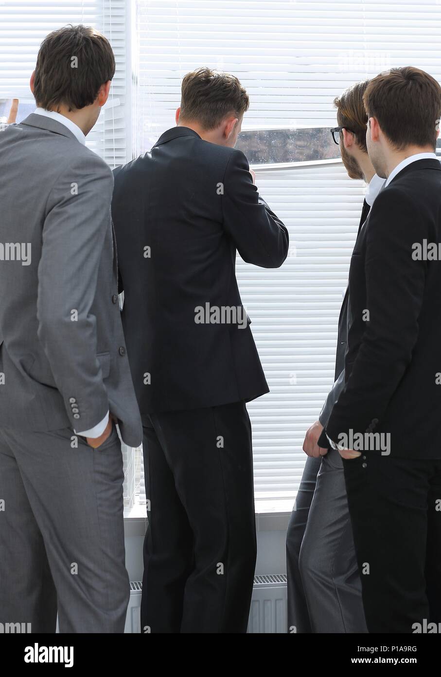 business partners communicate standing near window in office Stock ...