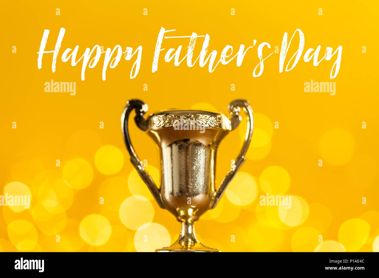 Gold father's day award trophy against bright yellow background Stock ...