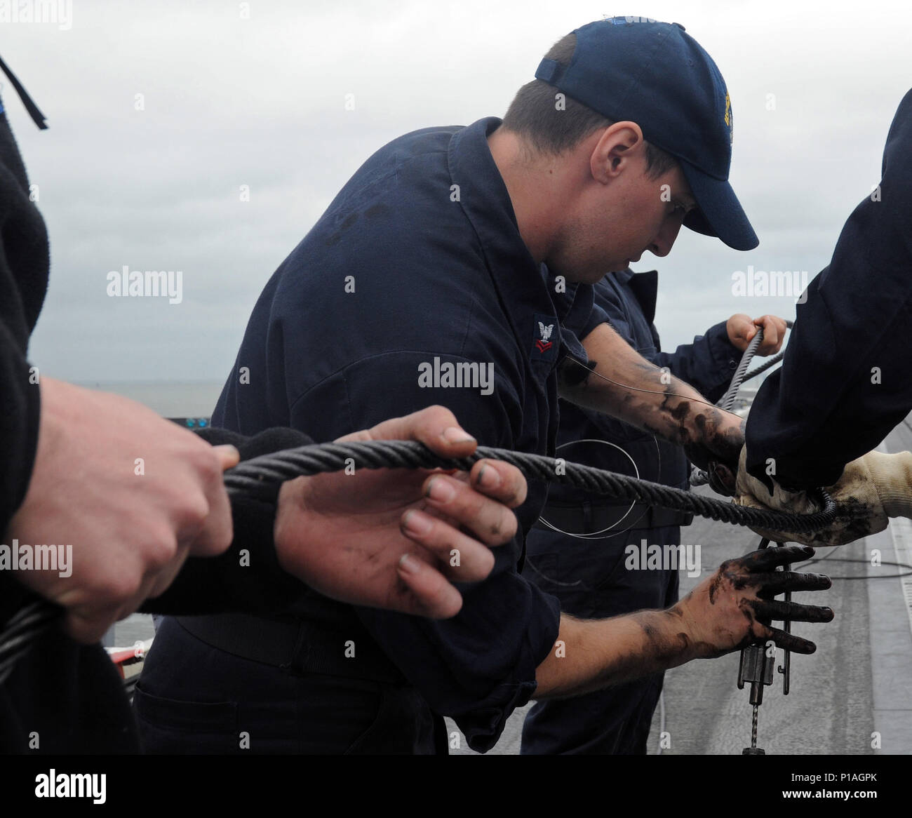 161005-N-GI441-027 NORFOLK (Oct. 5, 2016) Sailors reeve the wire from a ...