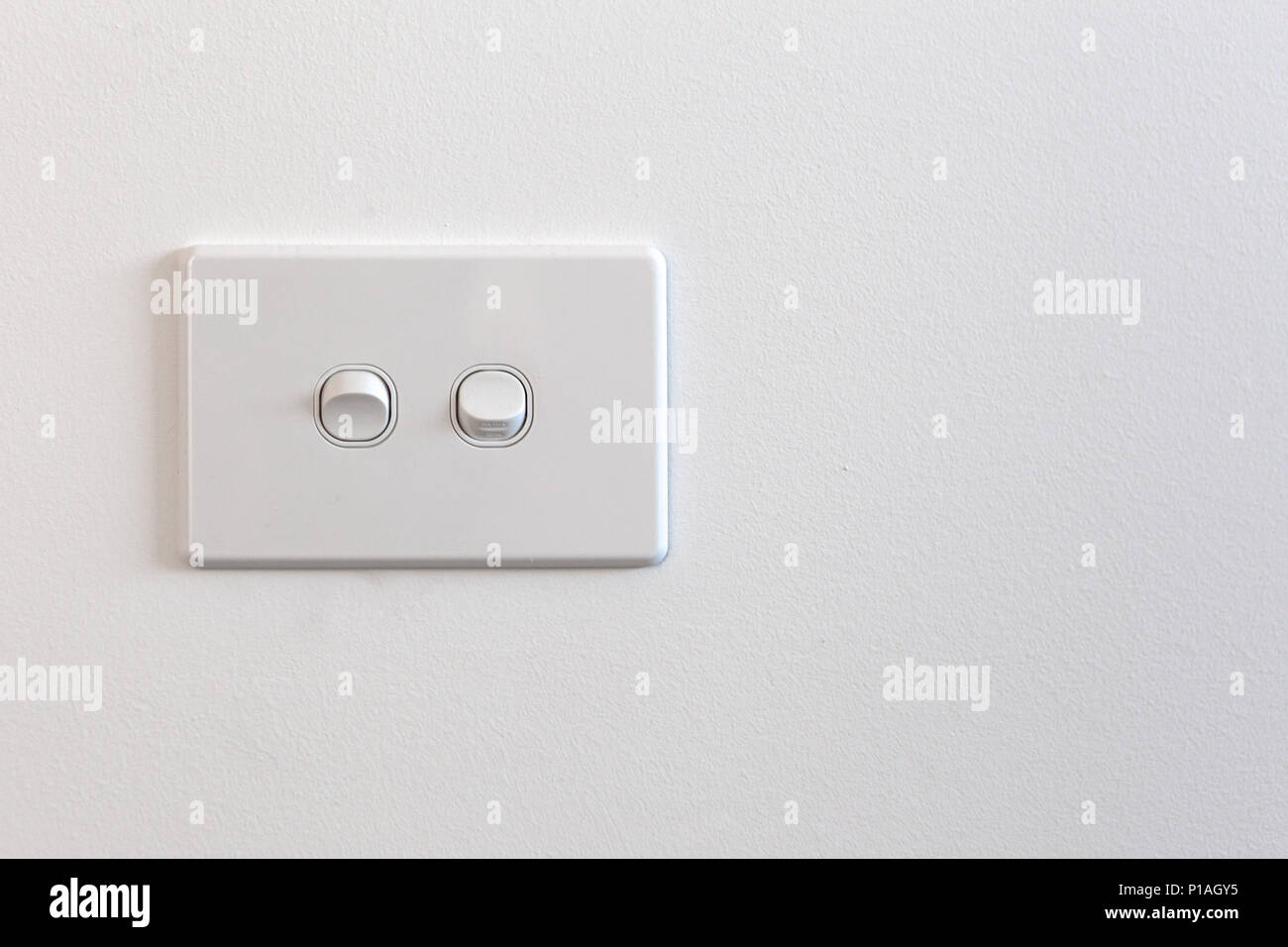 Modern double light switch on white wall with copy space Stock Photo ...