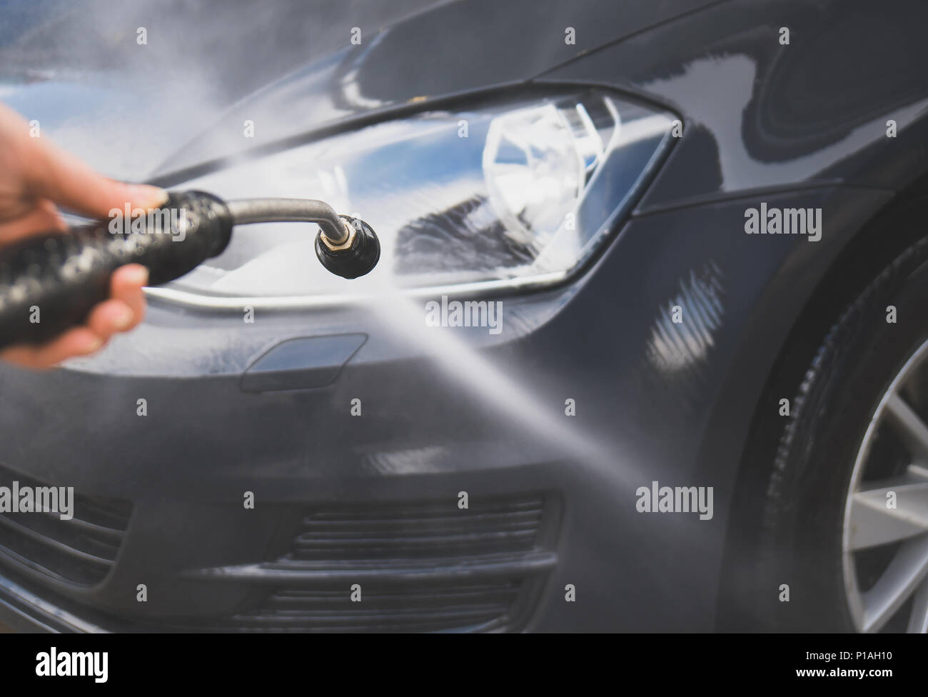 Car wash using high pressure water jet Stock Photo - Alamy