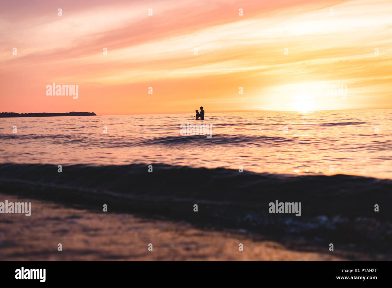 Two friends spend time together swimming in the sea , Europe Stock ...