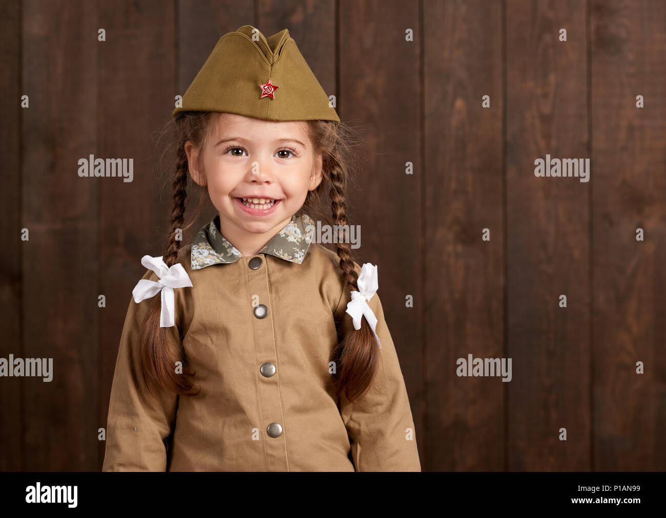 child girl are dressed as soldier in retro military uniforms Stock ...
