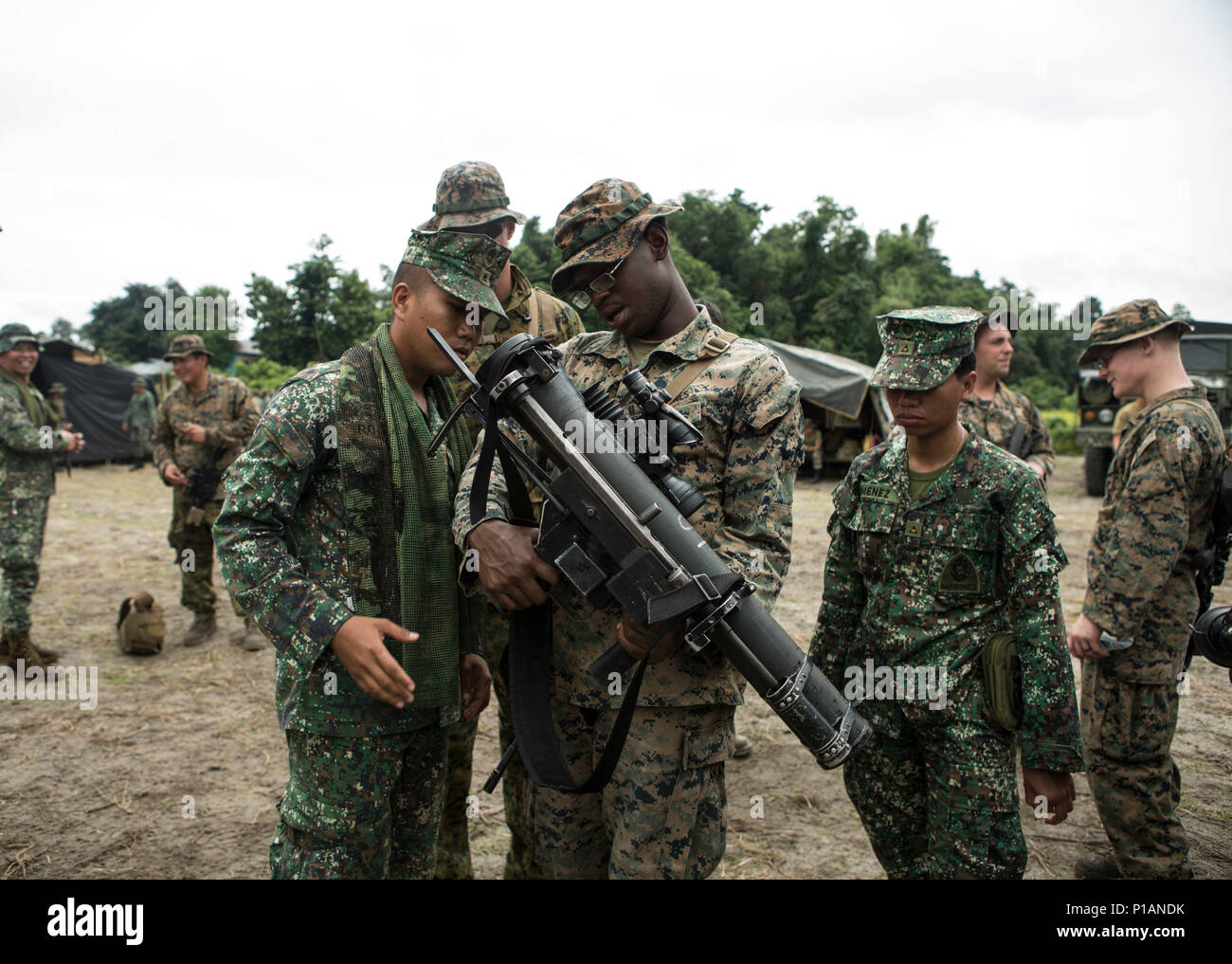 A U.S. Marine shows Philippine Marines the parts and functions of the ...