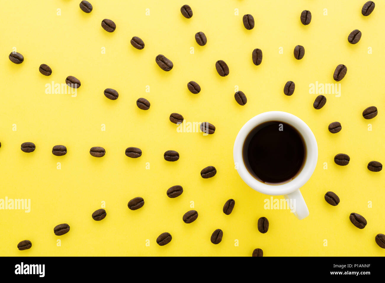 Cup of coffee espresso with sun rays of coffee beans on yellow ...