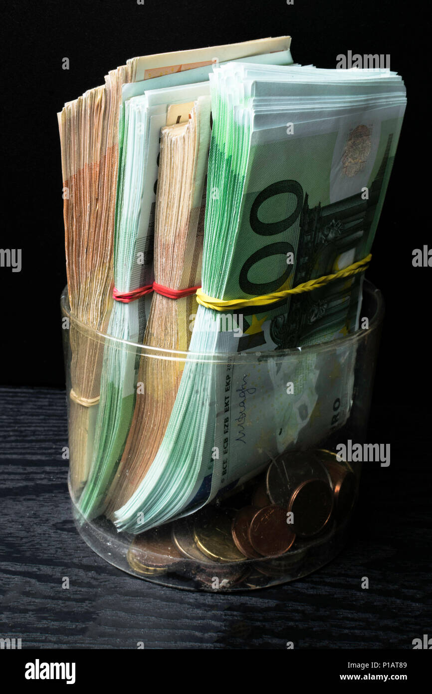 Saving money box with euro banknotes and cents.Banknotes of the ...