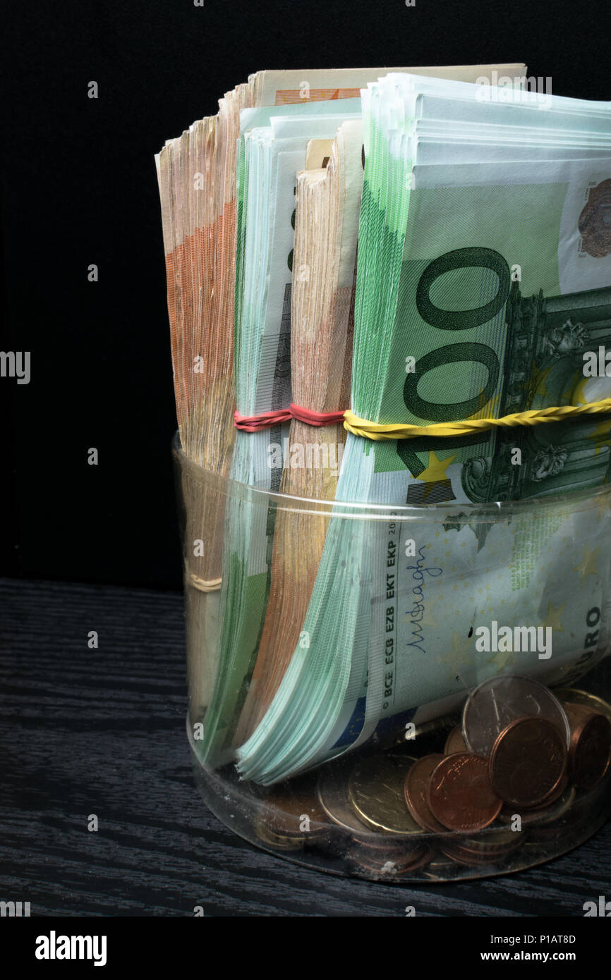 Saving money box with euro banknotes and cents.Banknotes of the ...