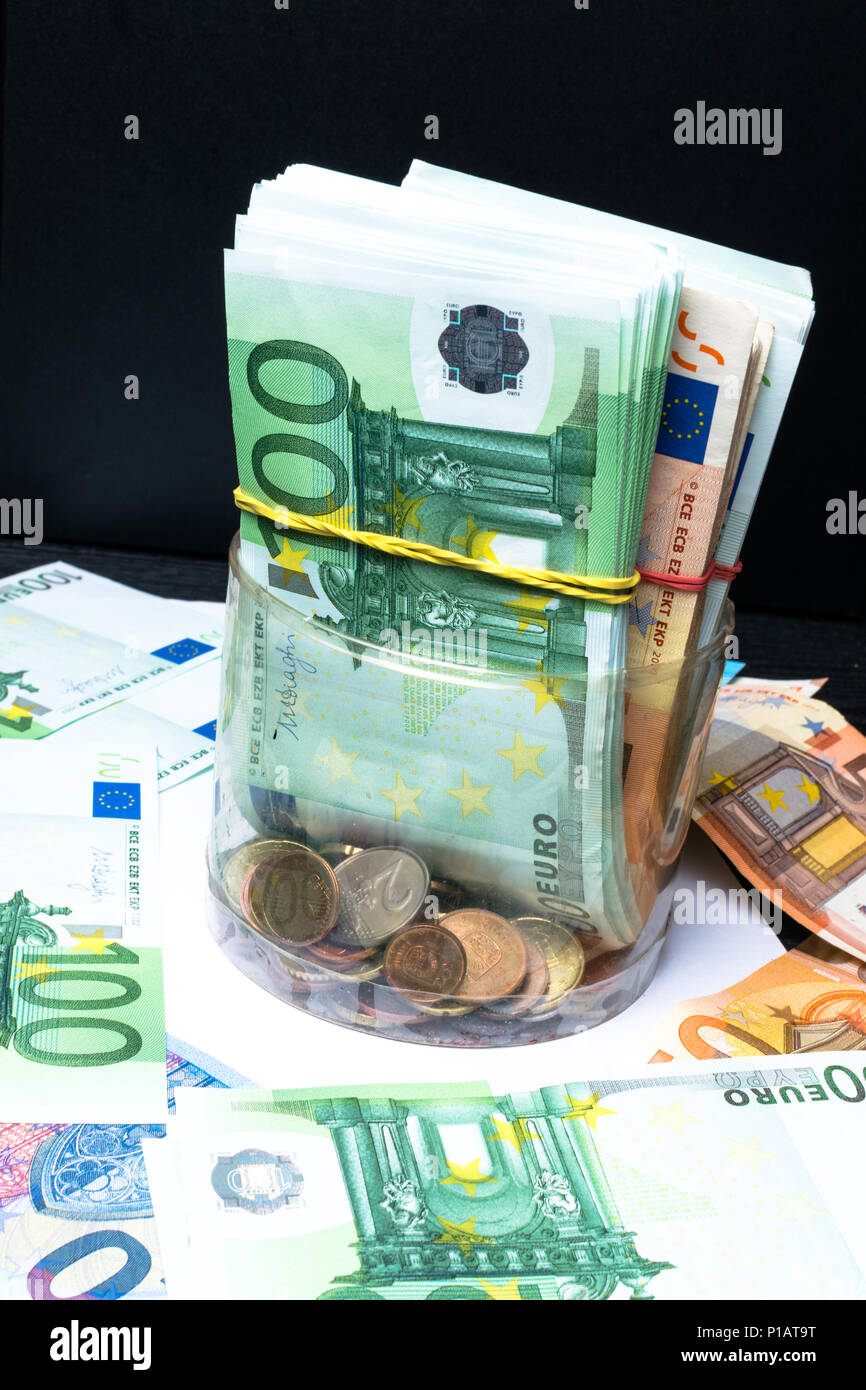 Saving money box with euro banknotes and cents.Banknotes of the ...