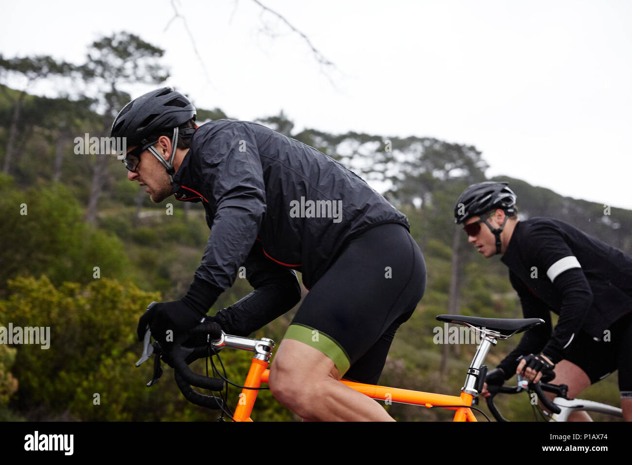 Focused, determined male cyclist cycling uphill Stock Photo - Alamy