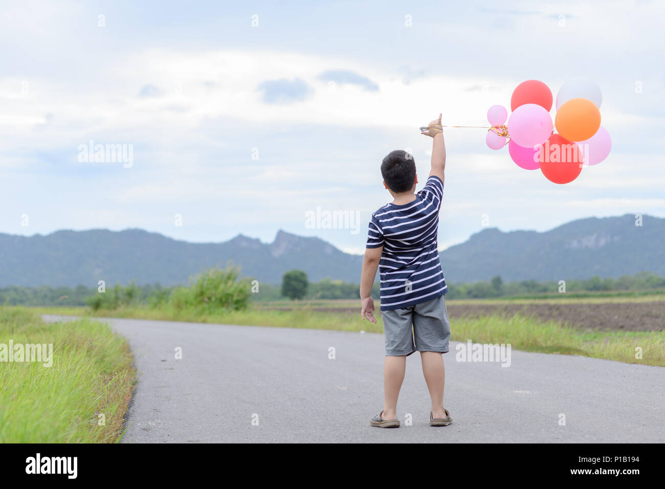back side fat boy with colorful balloon on nature background,Happy and ...
