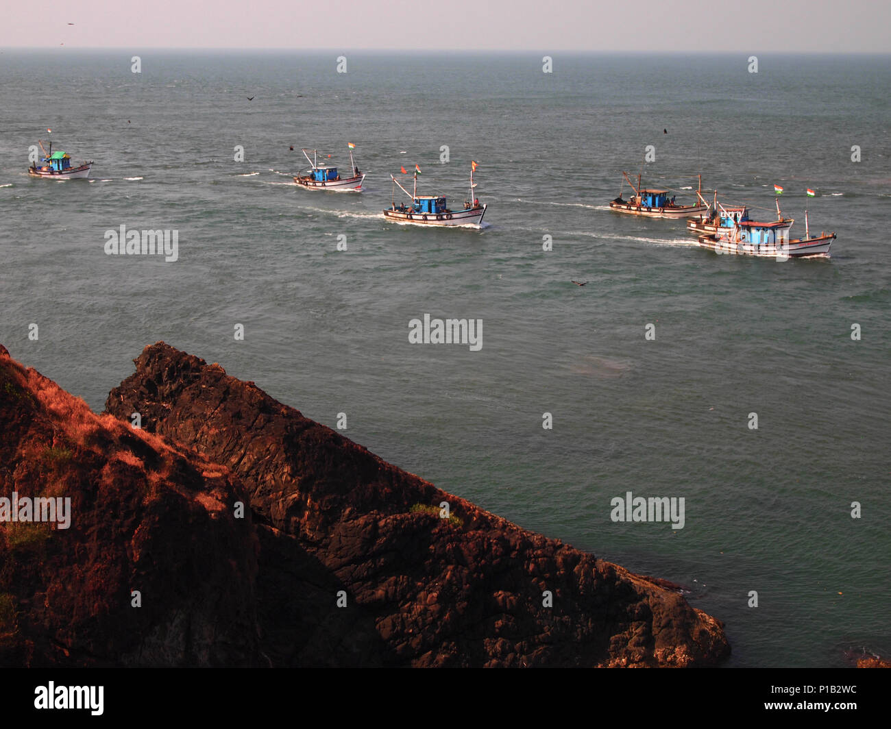 Artisanal fisheries fleet returning to port after a day’s fishing, in ...