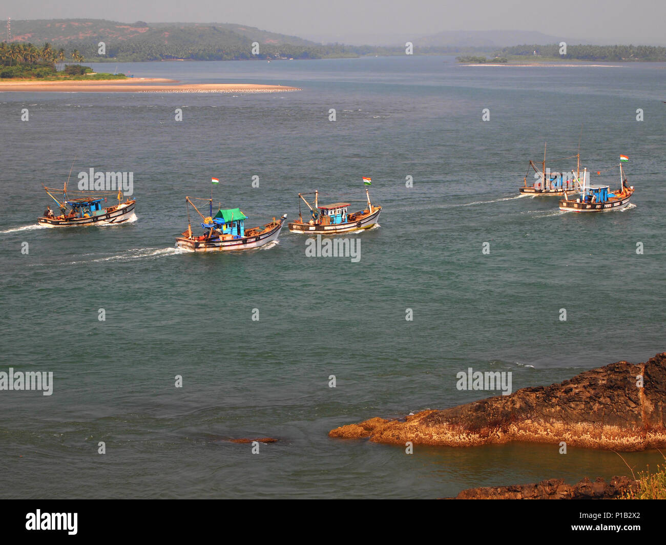 Artisanal fisheries fleet returning to port after a day’s fishing, in ...