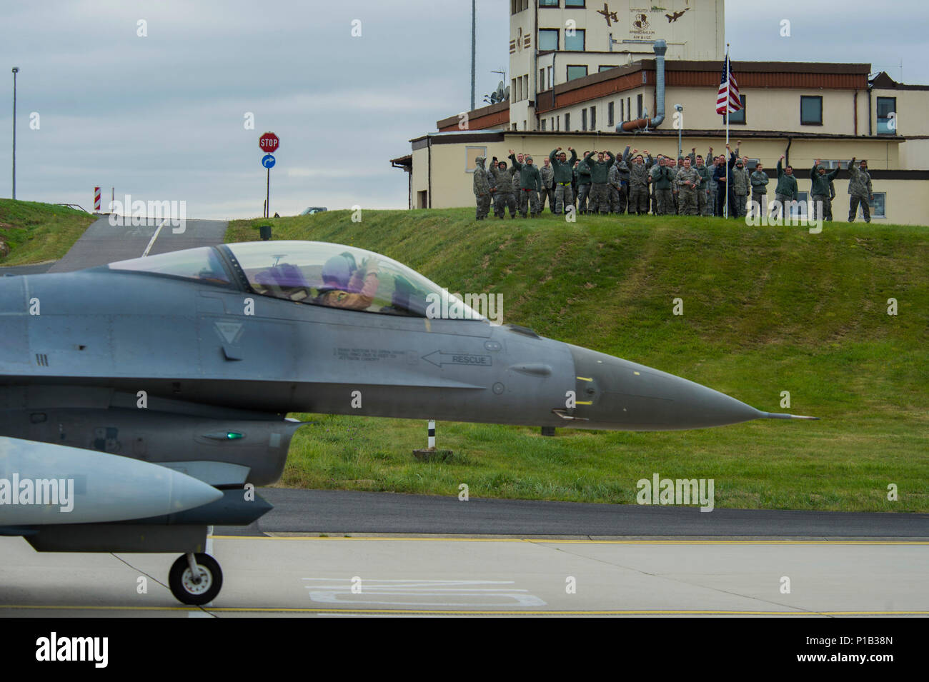 Airmen assigned to the 52nd Fighter Wing wave as an F-16 Fighting ...