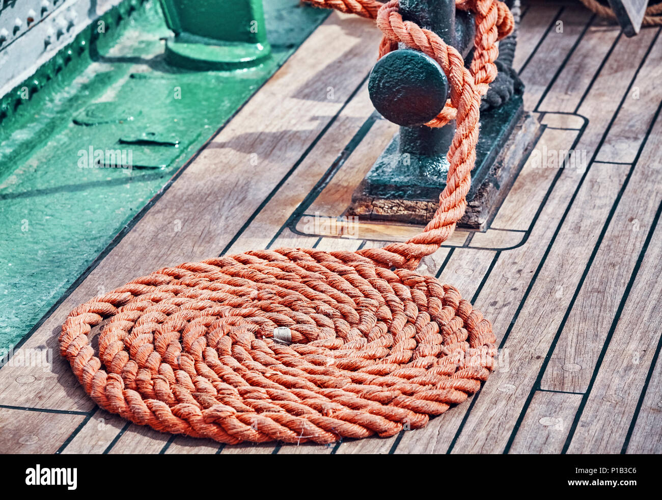 Vintage toned picture of a rope on an old sailing ship wooden deck ...