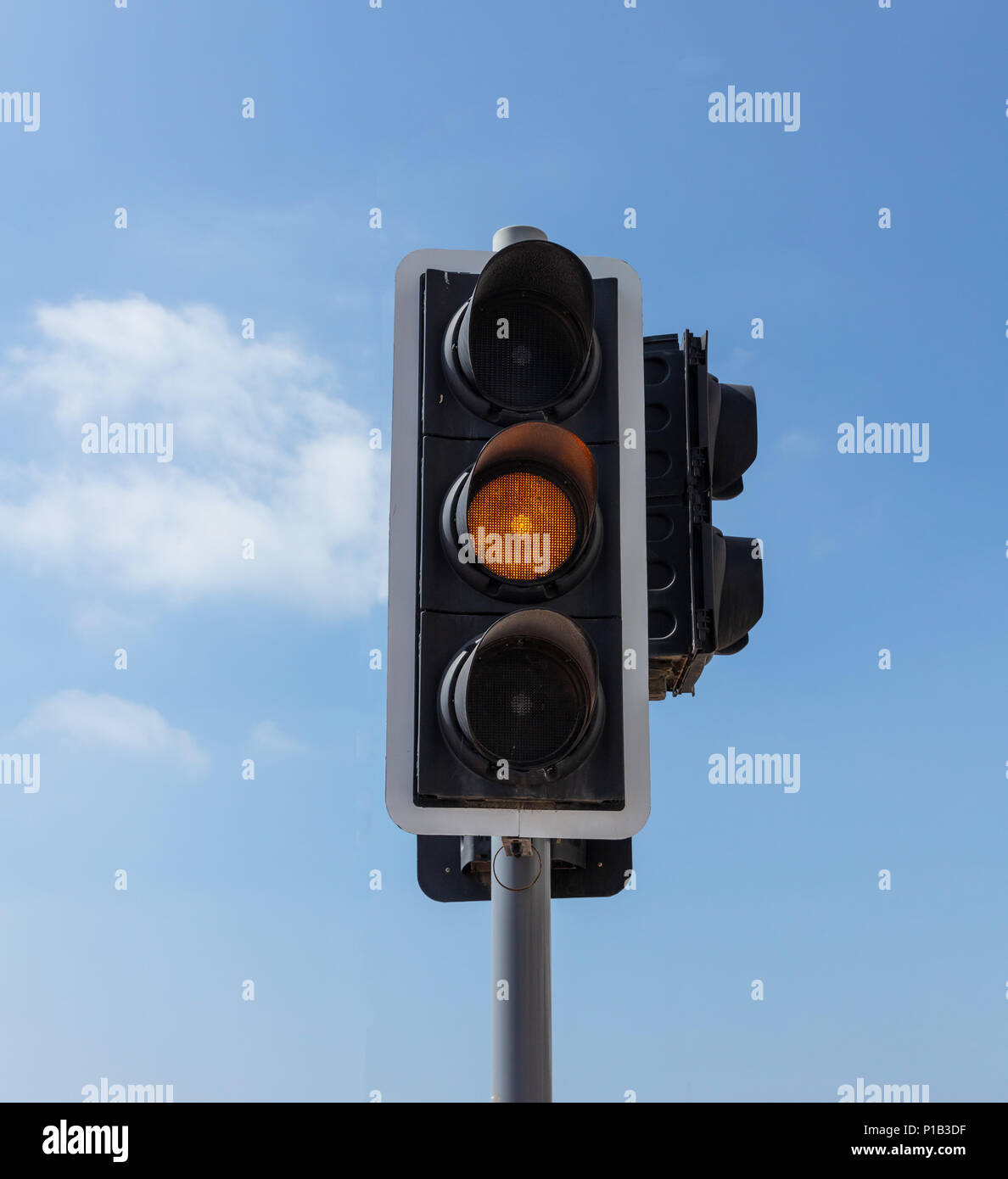 Orange signal, urban traffic lights for cars, blue sky background Stock ...