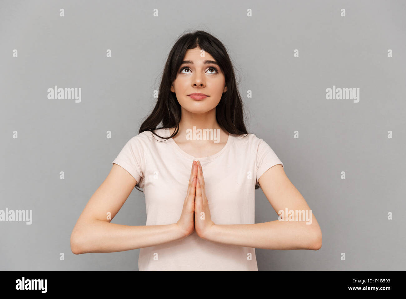 Photo of pretty nervous young lady isolated over grey background wall ...