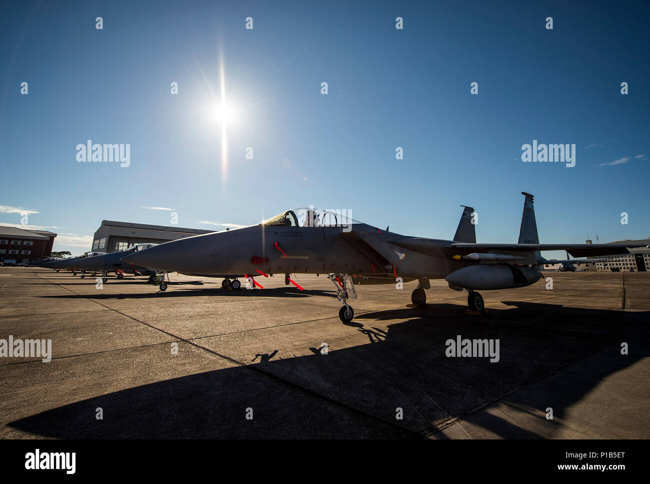 Clear skies and bright sun shines down on a row of 125th Fighter Wing F ...