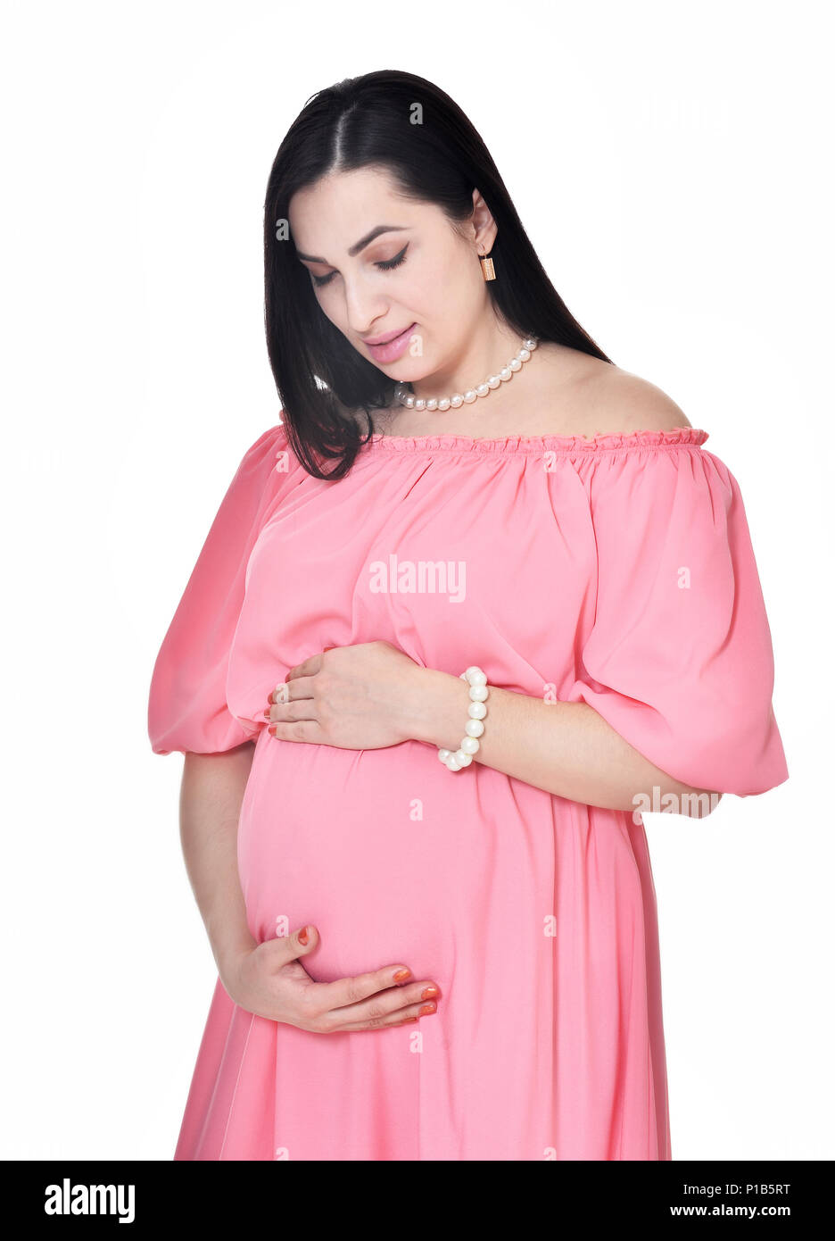 Beautiful pregnant woman in pink dress Stock Photo - Alamy