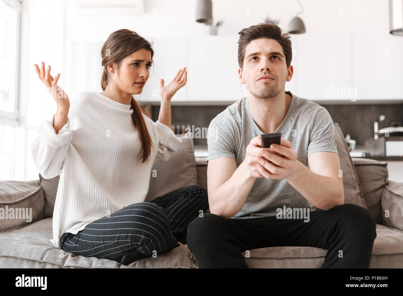 Upset woman husband watching tv hi-res stock photography and images - Alamy