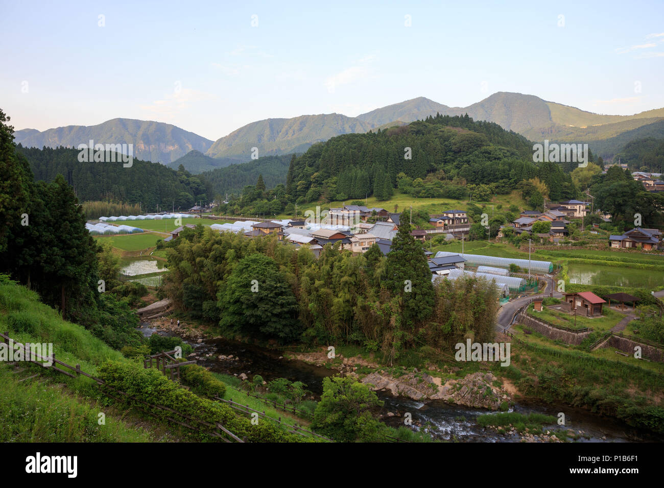 Small Japanese farming town surrounded by green mountains and trees ...