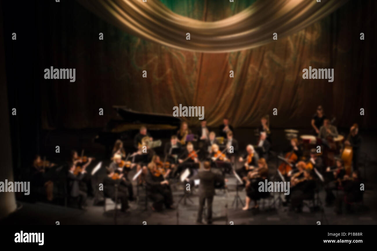 Artists symphony orchestra. abstract blurred image. Musician plays a ...