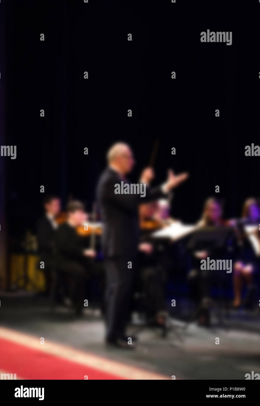 Orchestra conductor manages the orchestra. musical concept. blurred ...
