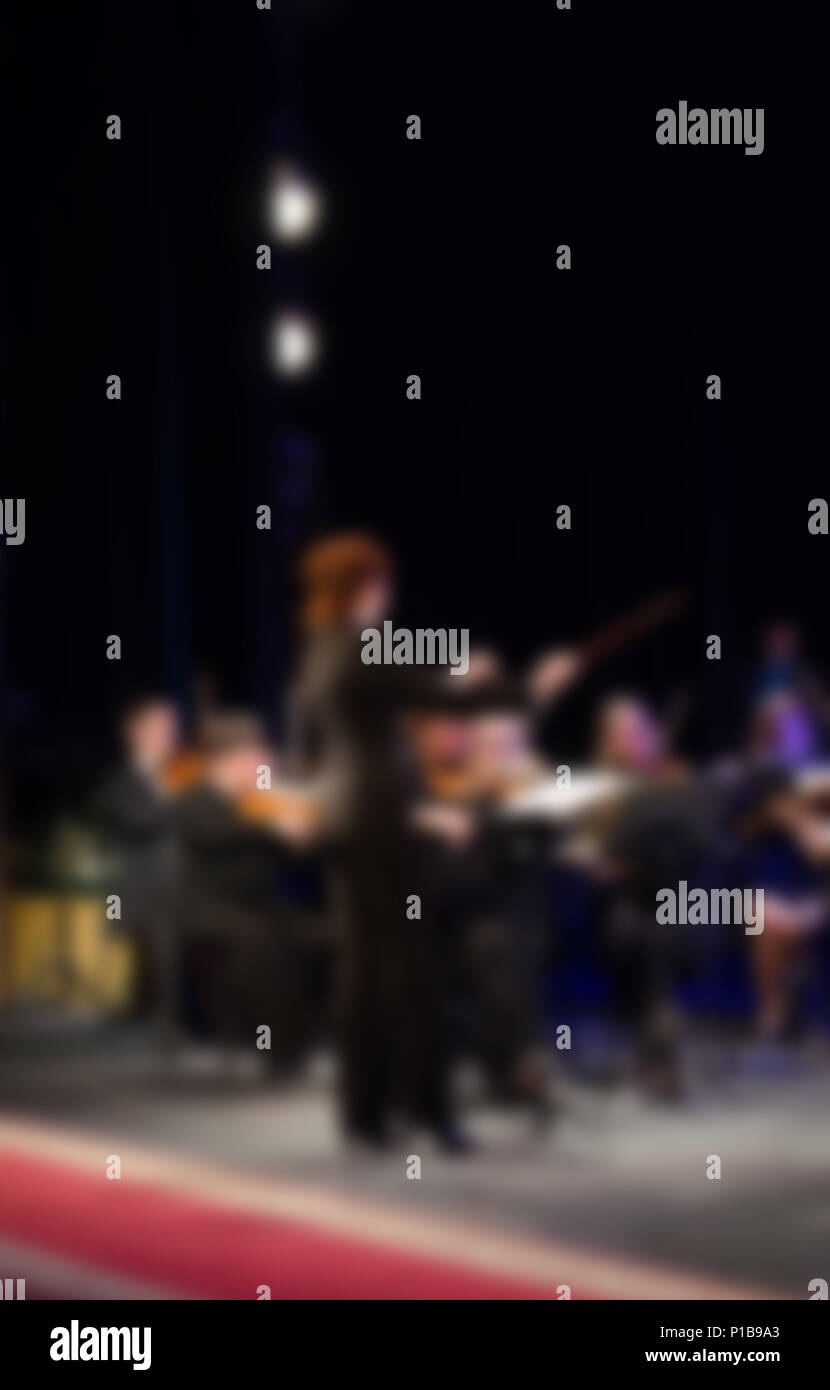 Orchestra conductor manages the orchestra. musical concept. blurred ...