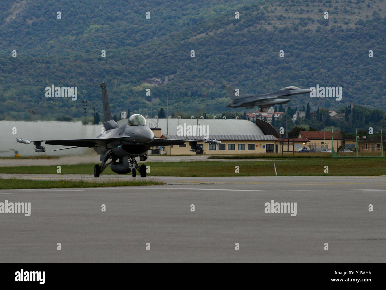 A 555th Fighter Squadron F-16 Fighting Falcon taxis across the runway ...