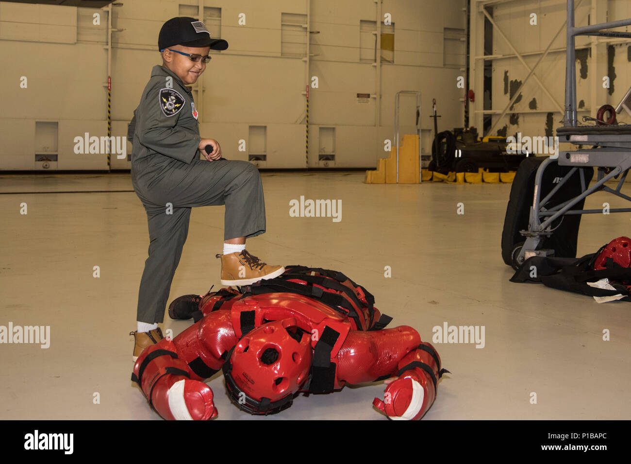 Kwami uses a baton to neutralize the “redman,” or training aggressor ...