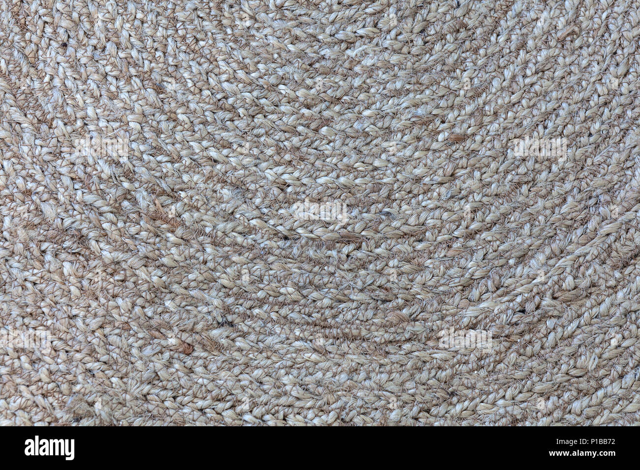 Jute braided spiral rug texture background clos-up Stock Photo - Alamy