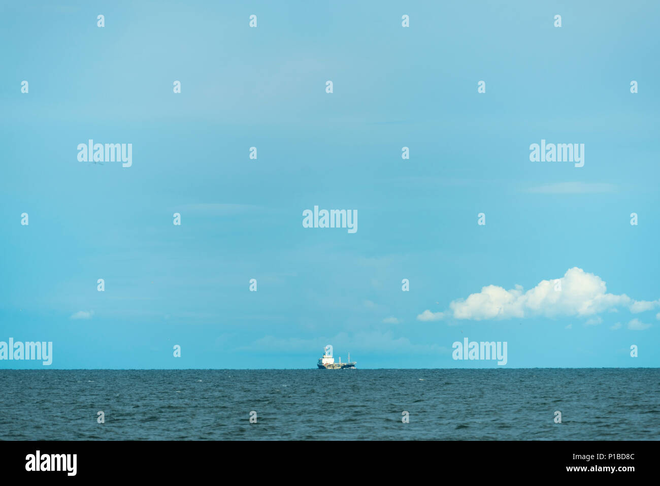 Large cargo ship in the middle of the ocean Stock Photo - Alamy