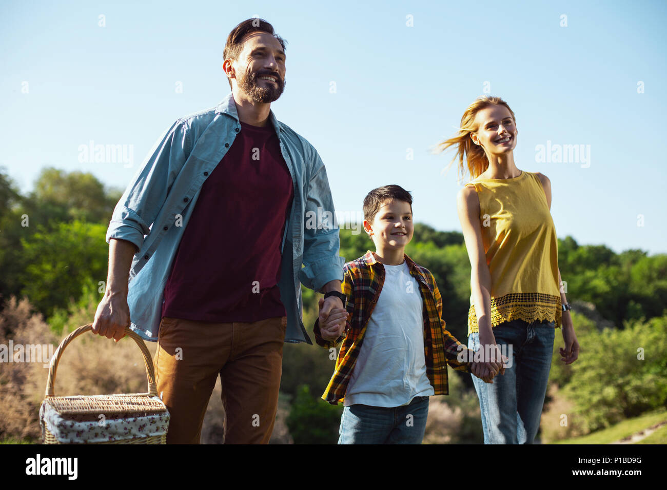 Alert family having a walk in the park Stock Photo - Alamy