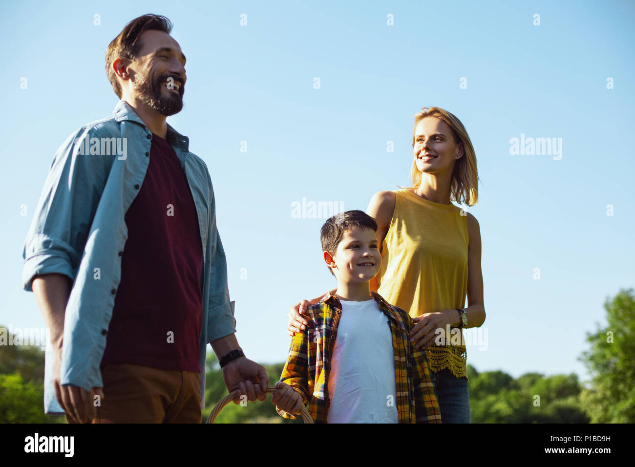 Exuberant family having a walk in the park Stock Photo - Alamy