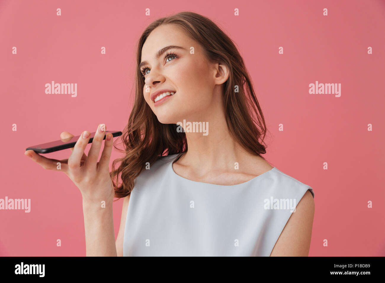 Image of cute young woman standing isolated over pink background ...