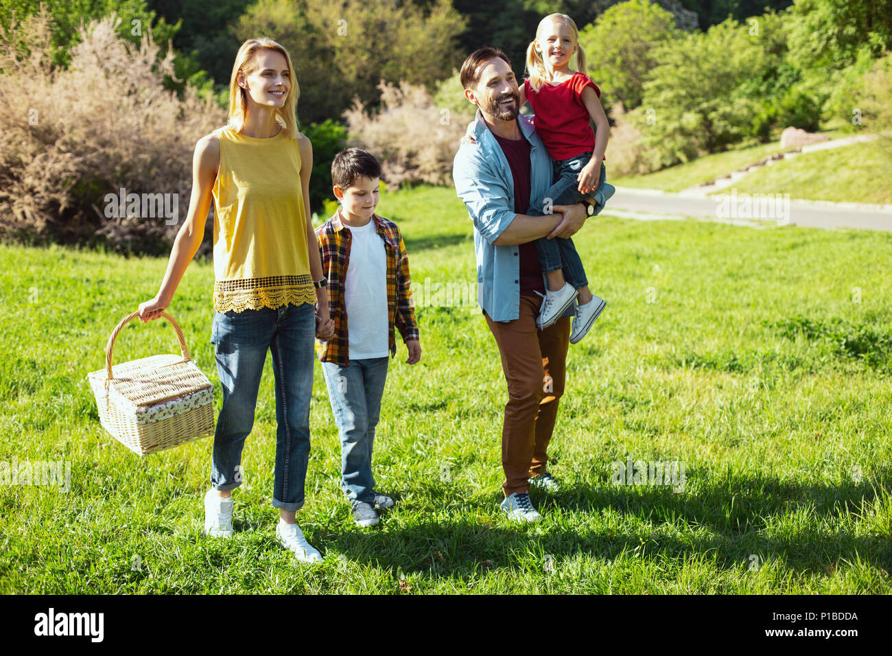 Happy parents walking with their kids Stock Photo - Alamy