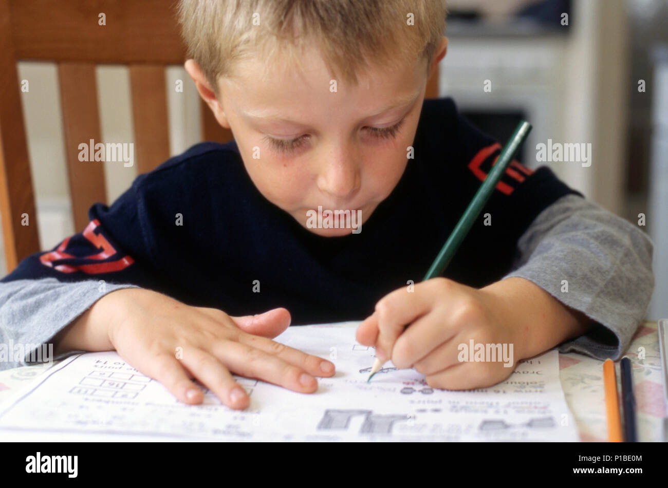 Young boy drawing with a pencil Stock Photo - Alamy