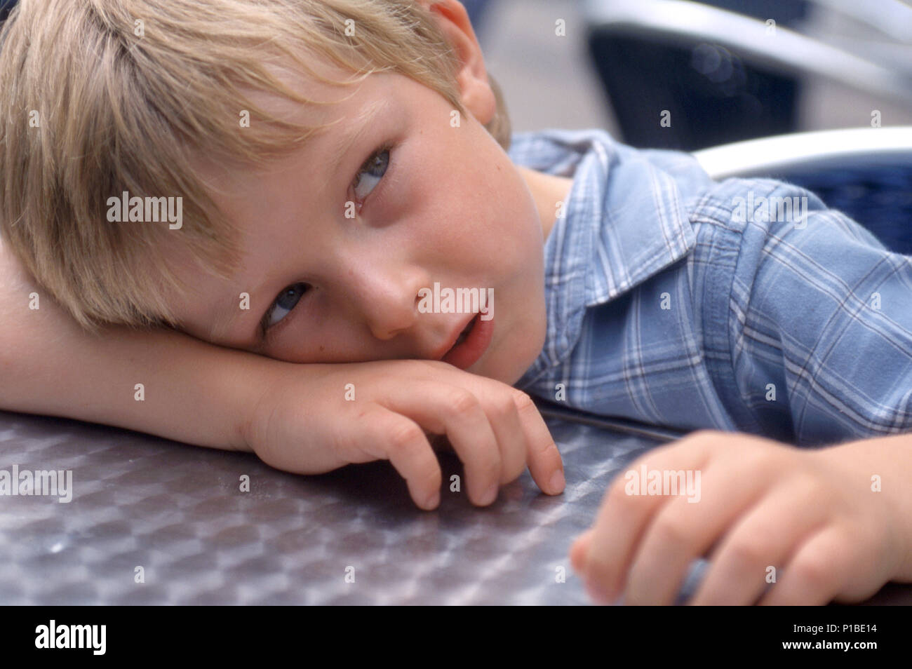 Young boy resting his head Stock Photo - Alamy