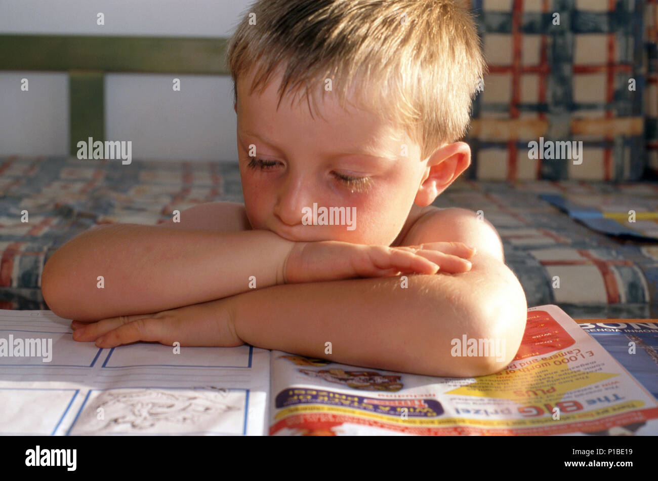 Young boy four years old reading a children's magazine Stock Photo - Alamy