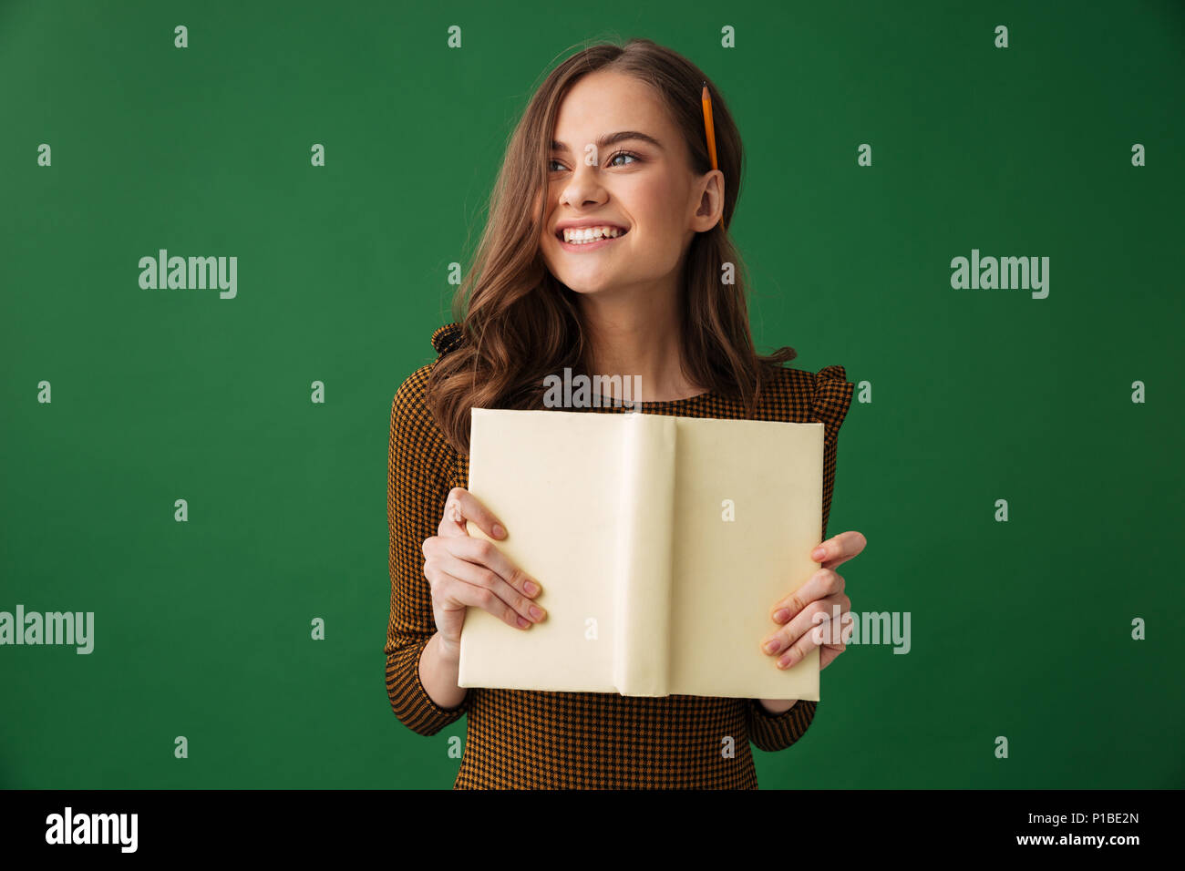 Image of amazing young woman standing isolated over green background ...