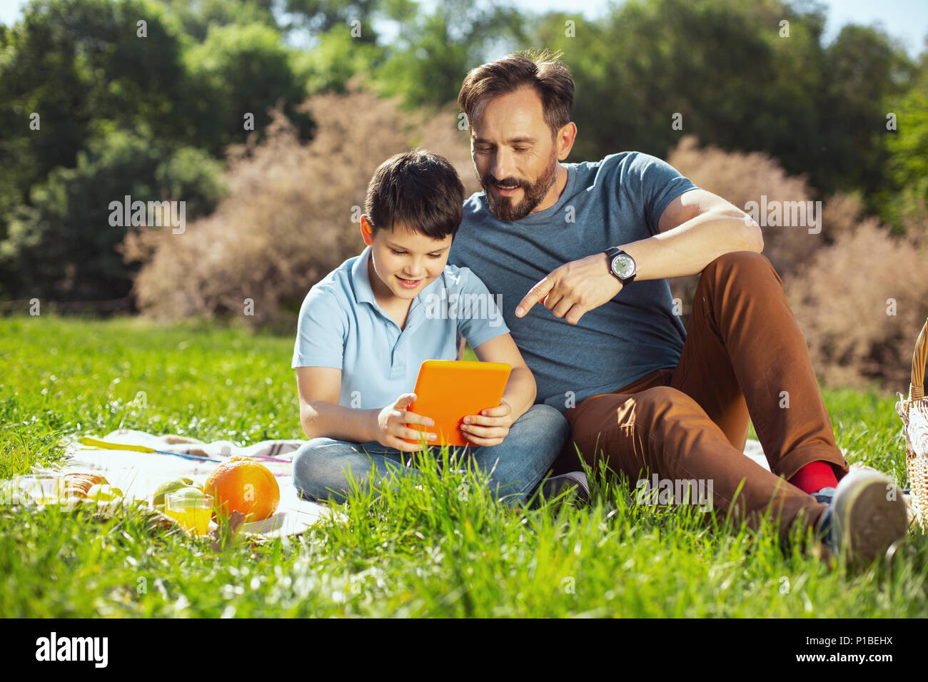 Cheerful daddy spending time with his son Stock Photo - Alamy