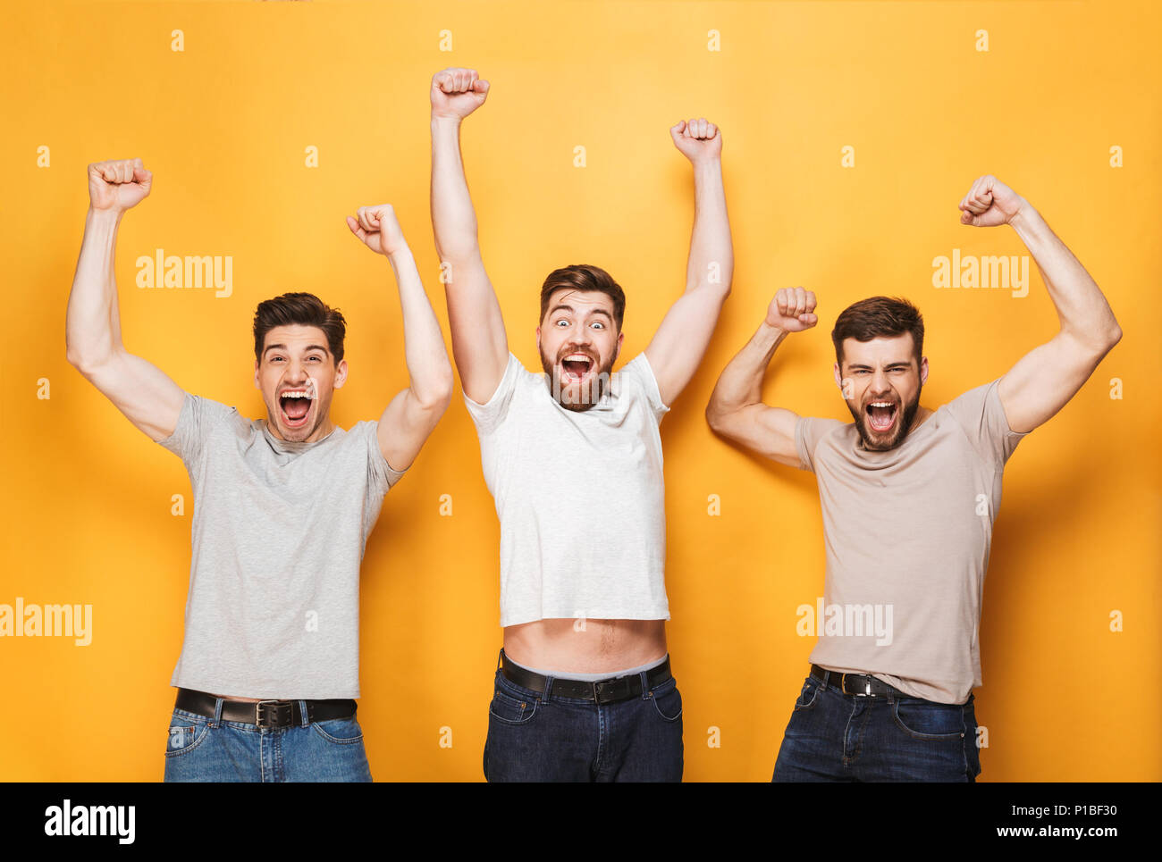 Three young excited men celebrating success and screaming isolated over ...