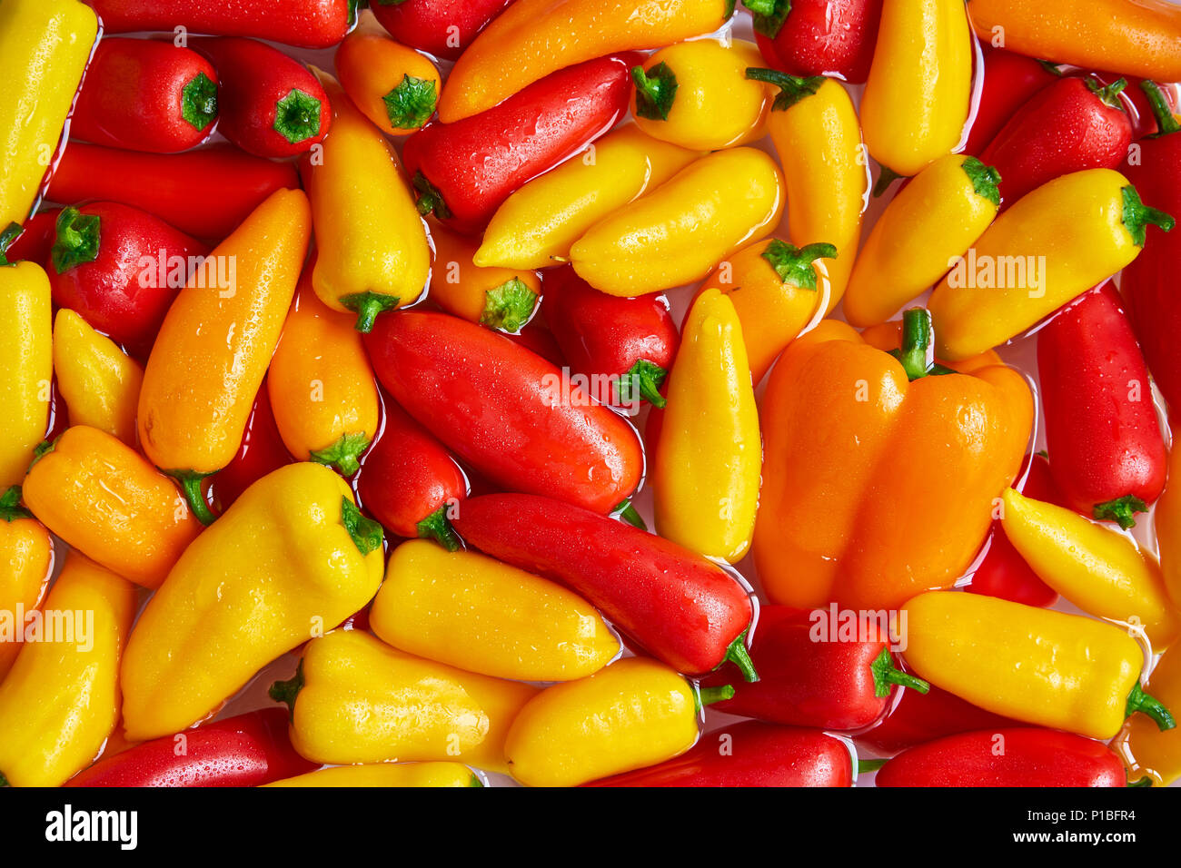 Vegetarian textures. Group of fresh delicious bell peppers: red, yellow ...