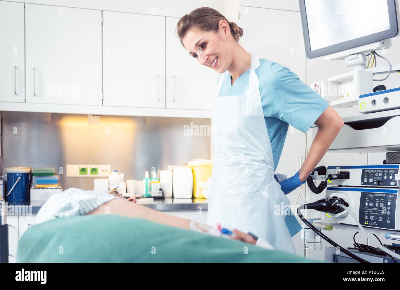 Nurse preparing herself and patient for endoscopy Stock Photo - Alamy