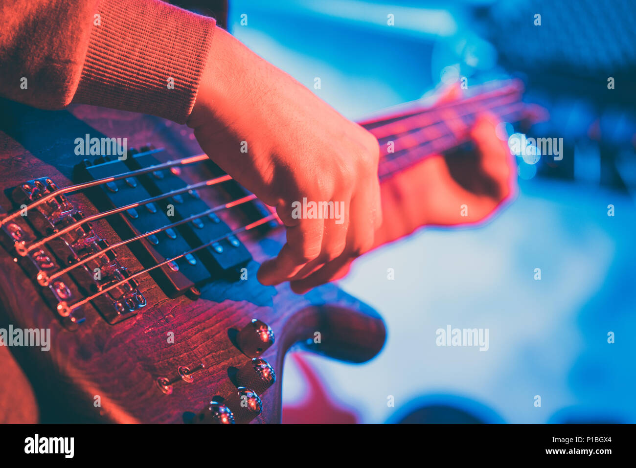 Guitar player in front of amplifier Stock Photo - Alamy