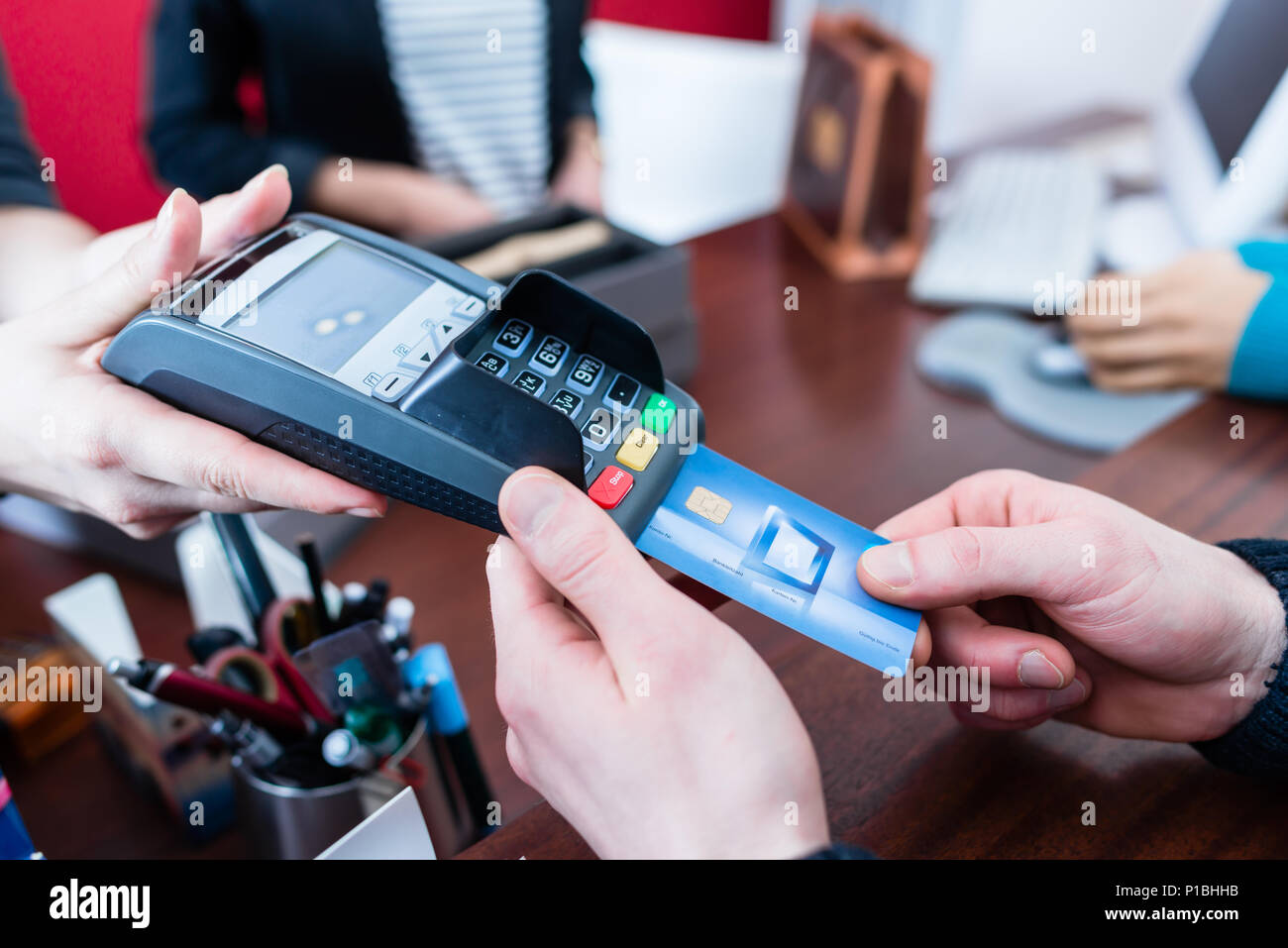 Customer paying with credit card in shop Stock Photo - Alamy