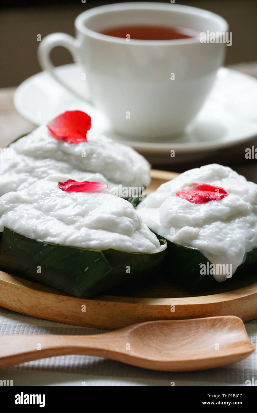 Thai pudding with coconut topping on wood plate Stock Photo - Alamy