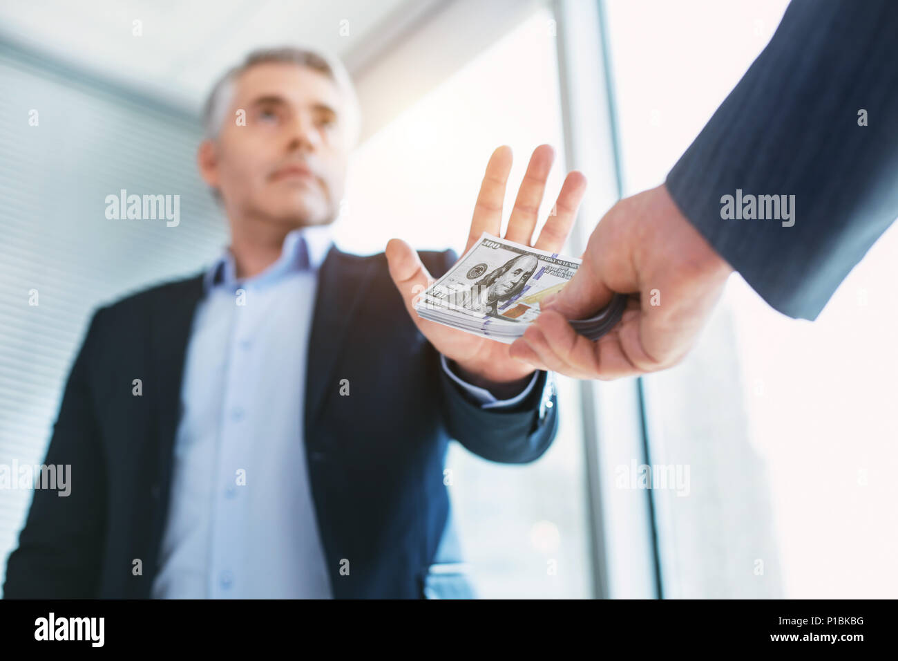 Determined businessman taking big bribes Stock Photo - Alamy