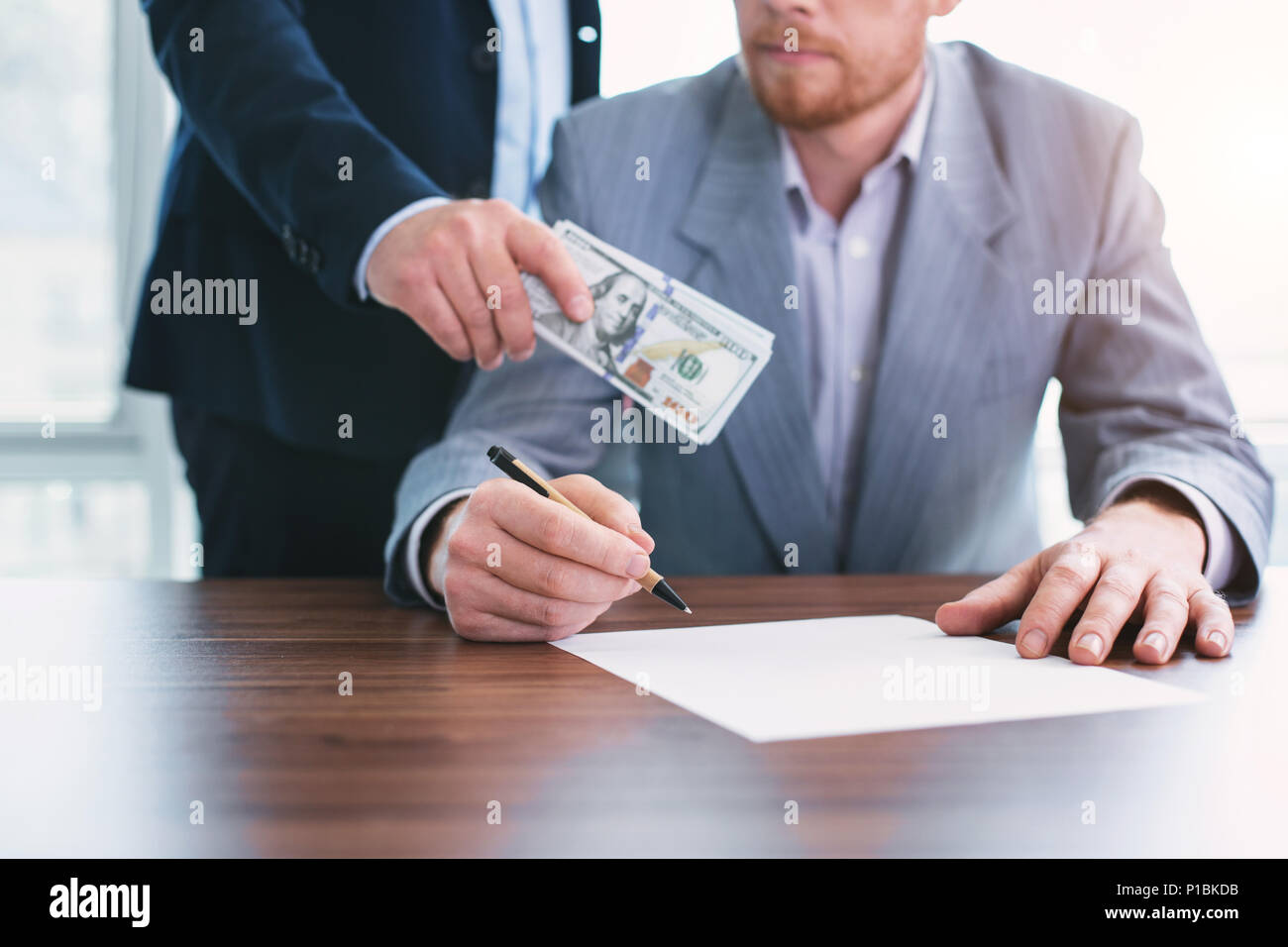 Influential official giving a bribe Stock Photo - Alamy