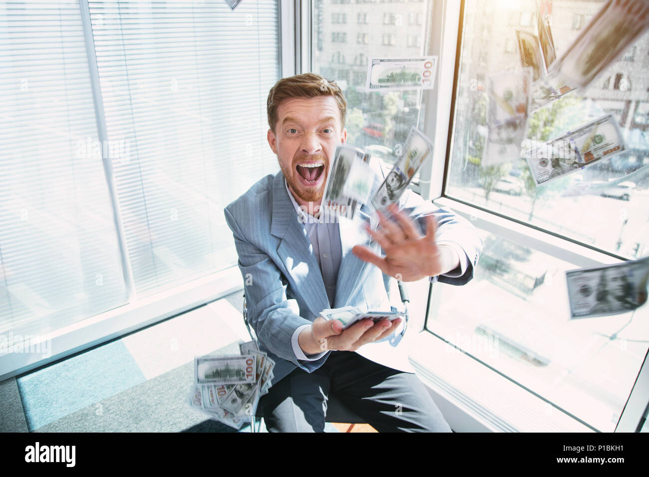 Excited official throwing money around him Stock Photo - Alamy